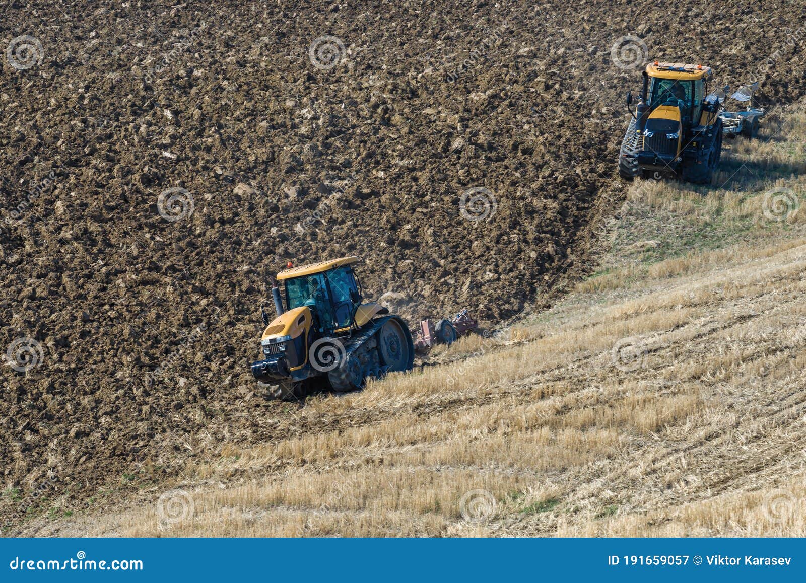 Two Tractors Plow a Field on a Hillside Stock Image - Image of tractor ...