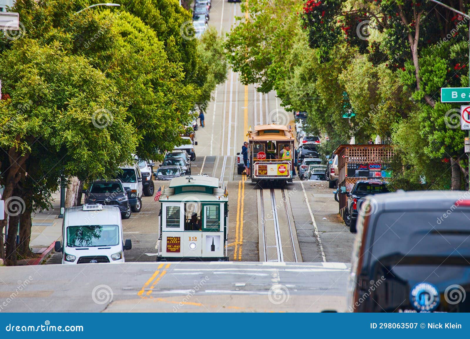 Two Trolleys on Bumpy Hilly Road One White and One Tan Going Down a ...