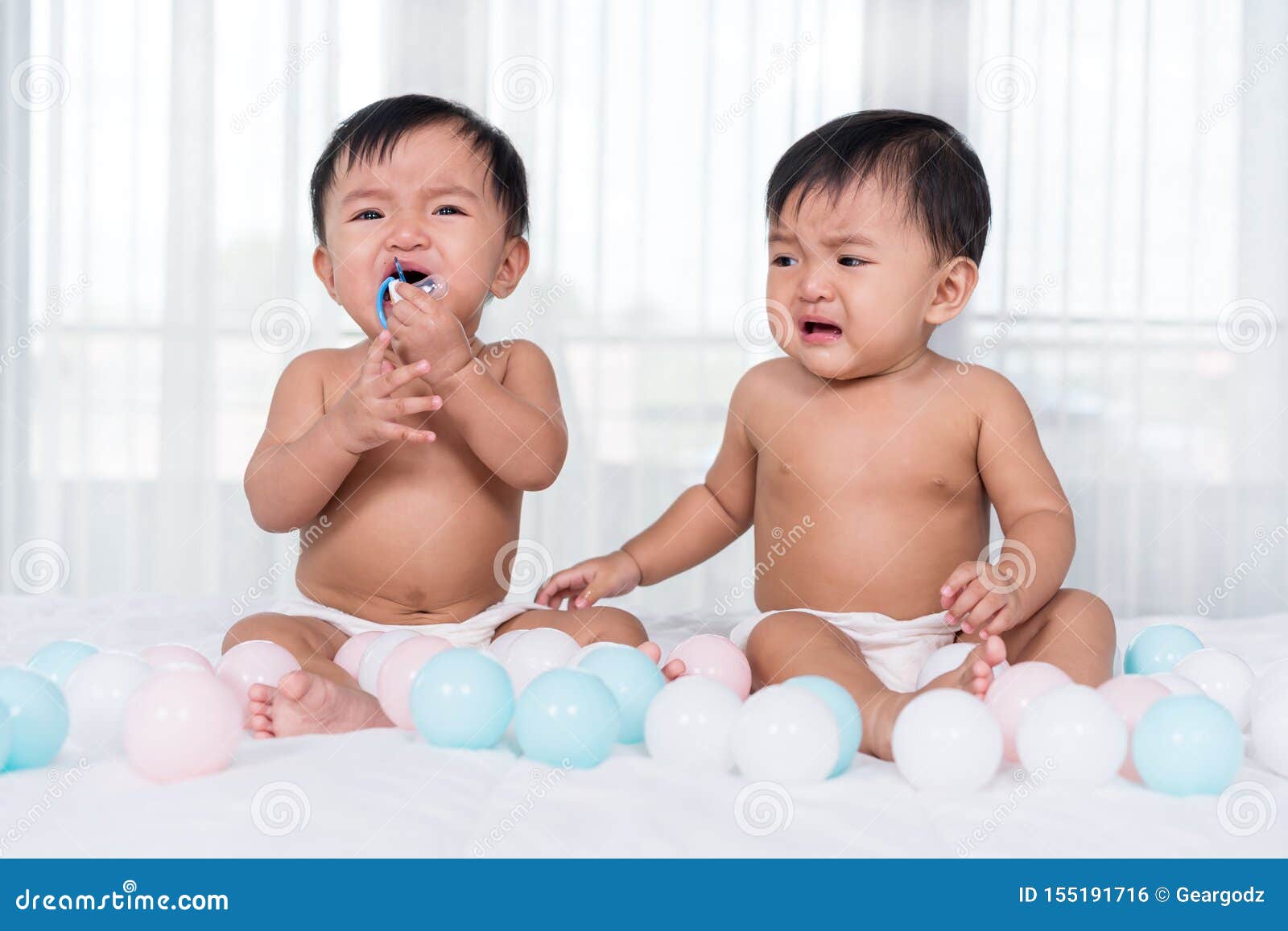 Two Twin Babies Crying on Bed Stock Photo - Image of cute, baby: 155191716