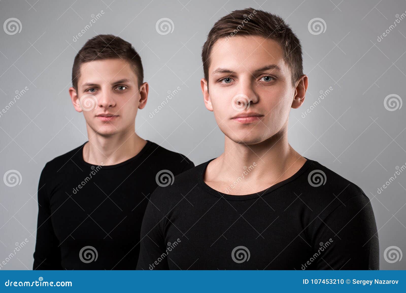 The Two Twin Brother Stand on the Gray Background Stock Photo - Image ...