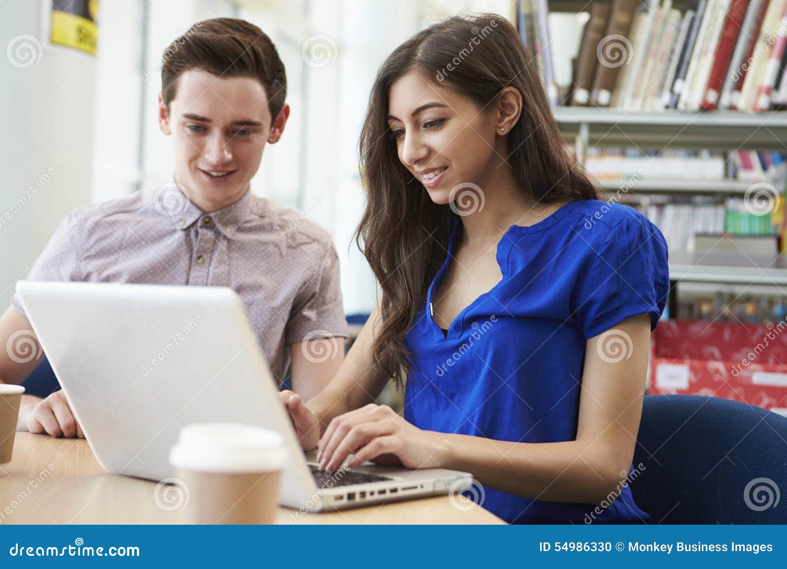 Two University Students Working in Library Using Laptop Stock Photo ...
