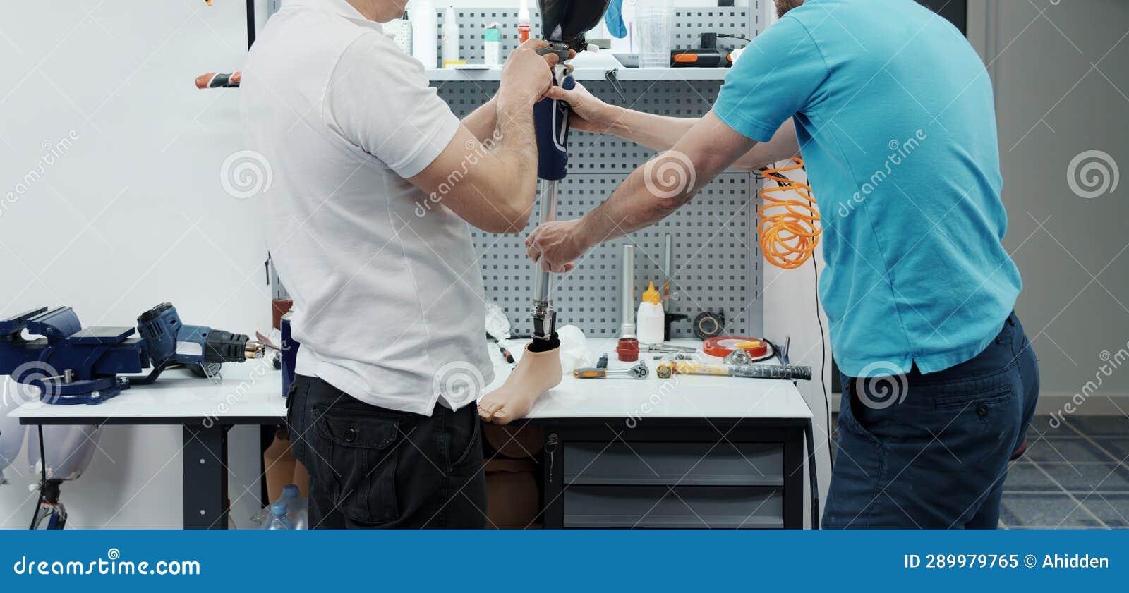 Two Unrecognizable Craftsman Adjusting and Bending Modern Prosthetic ...