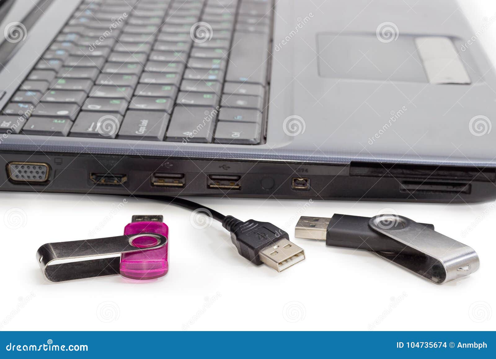 Two USB Flash Drives and USB Cable Against of Laptop Stock Photo ...