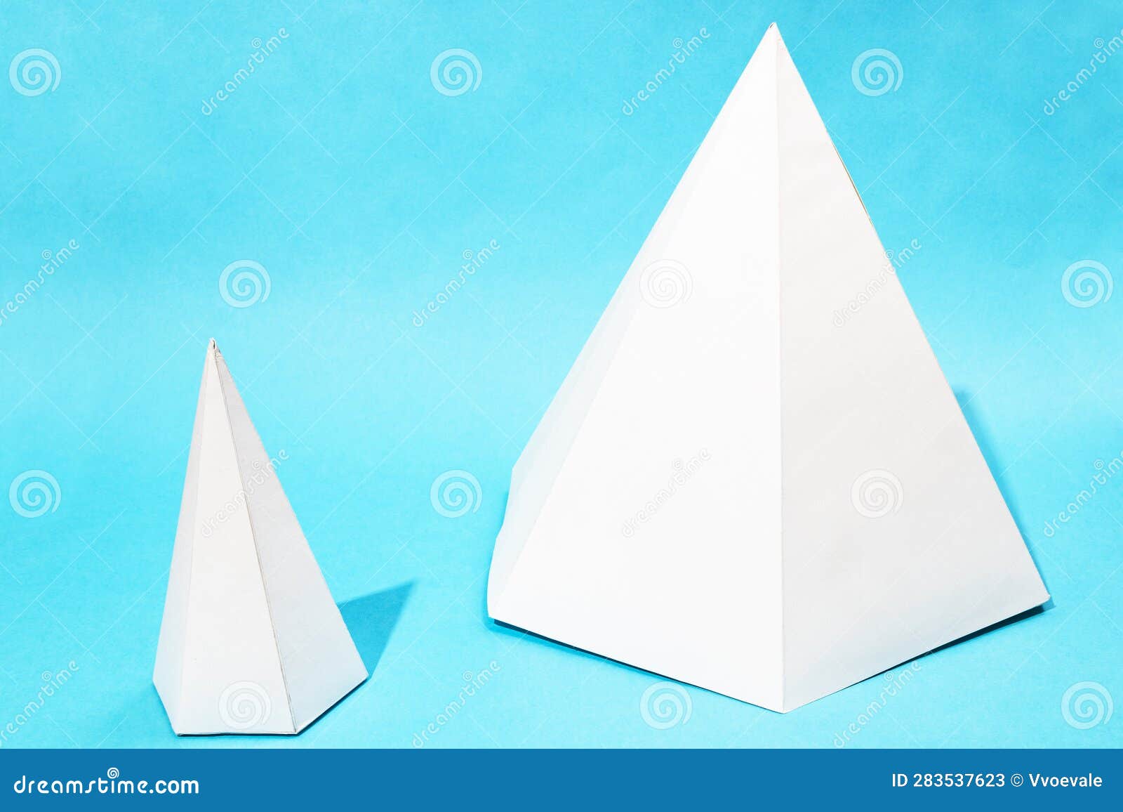 Two Various Hand-crafted Paper Pyramids on Blue Stock Image - Image of ...