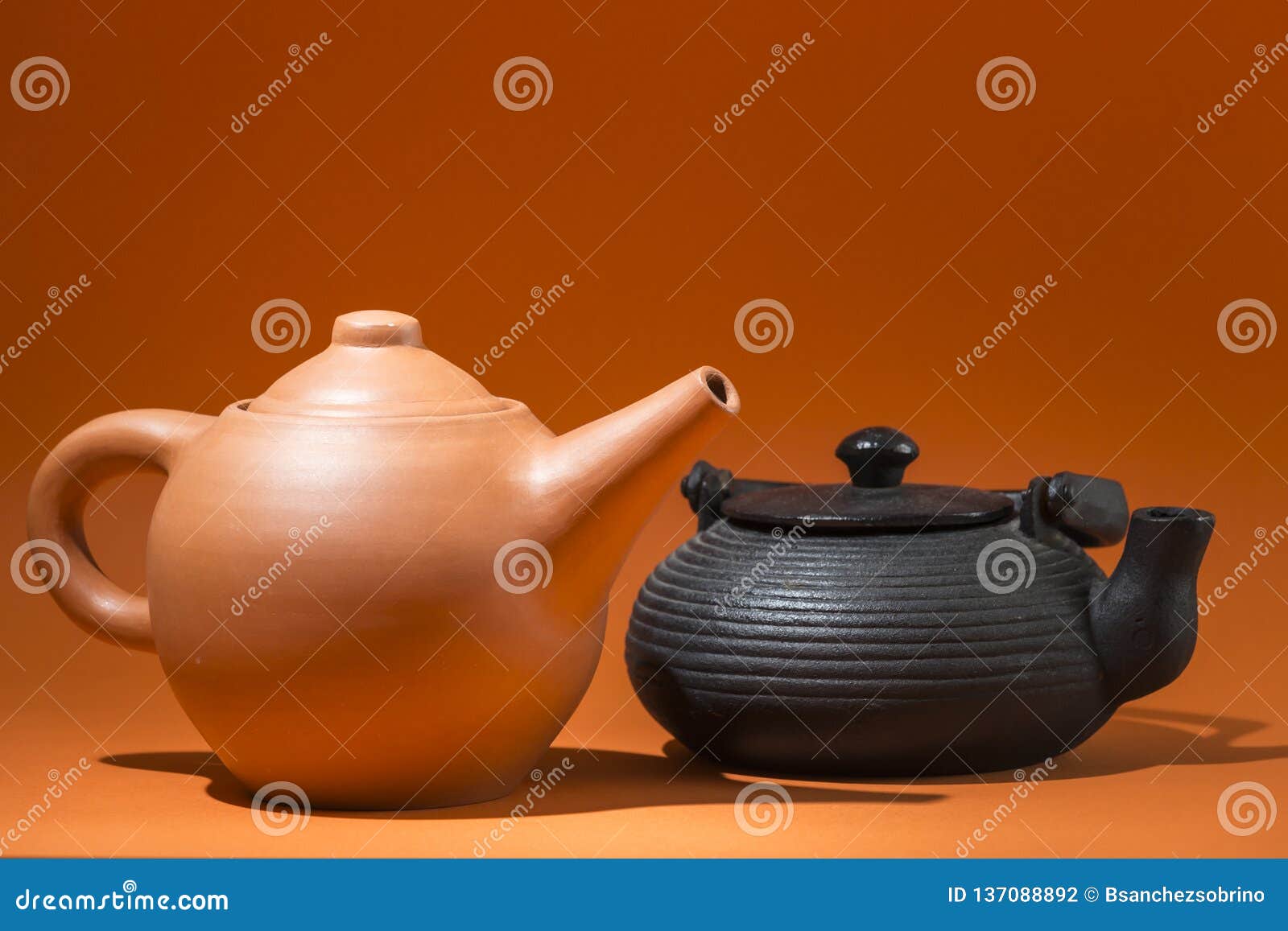 Two Very Different Teapots on an Orange Background Stock Photo - Image ...