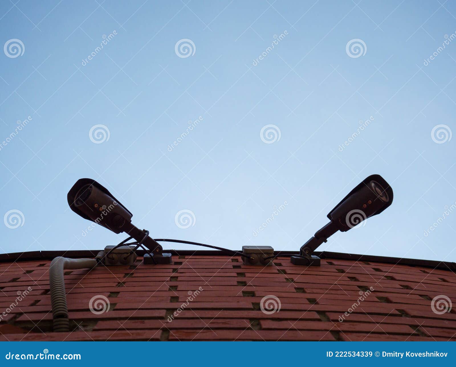 Two Video Surveillance Cameras Hanging on a Brick Wall. Stock Image ...
