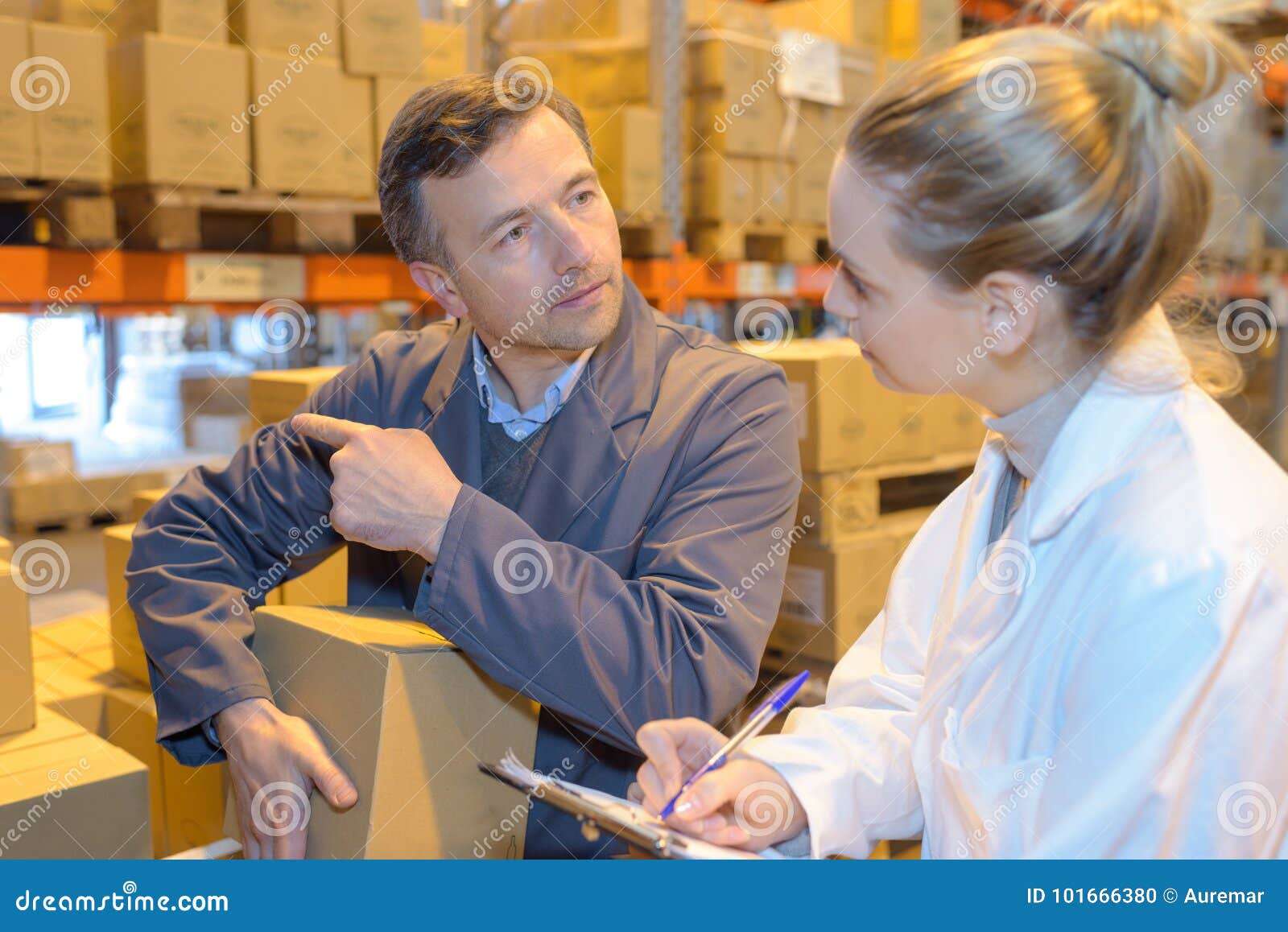 Two Warehouse Managers Checking Inventory in Large Warehouse Stock ...