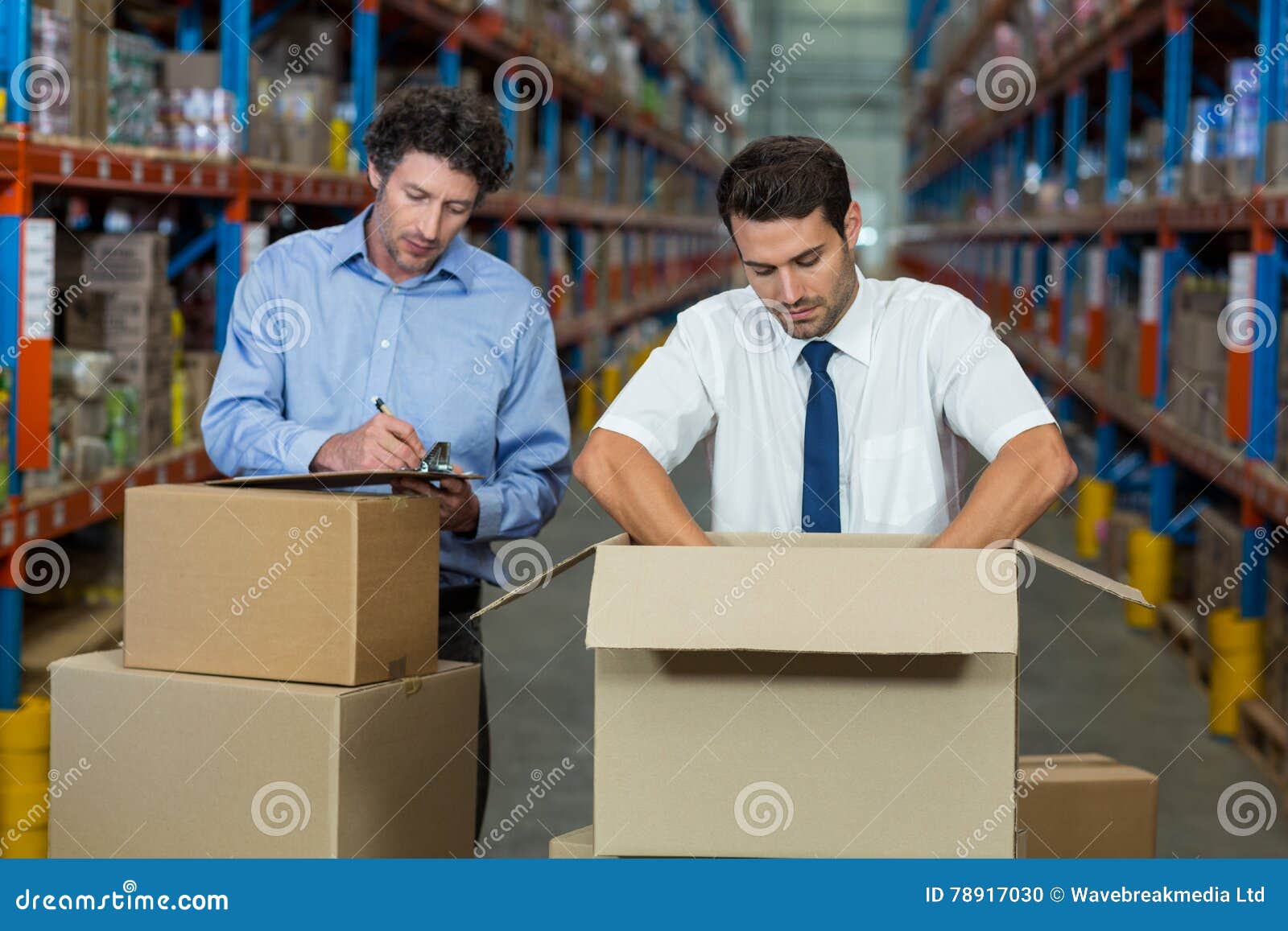 Two Warehouse Workers Checking the Boxes Stock Photo - Image of ...