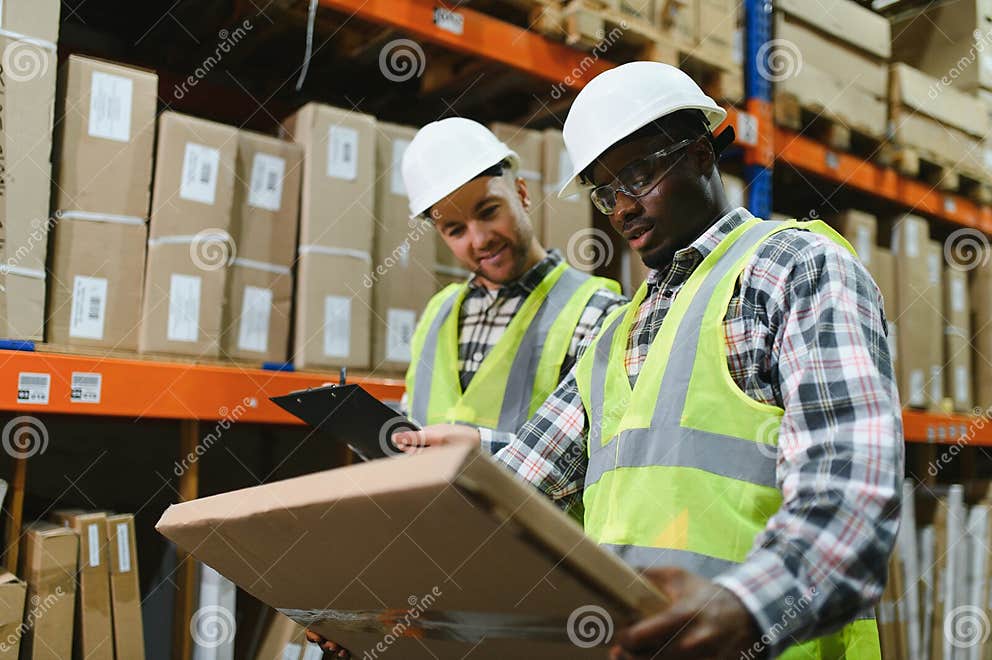 Two Warehouse Workers Checking and Controlling Boxes in Warehouse ...