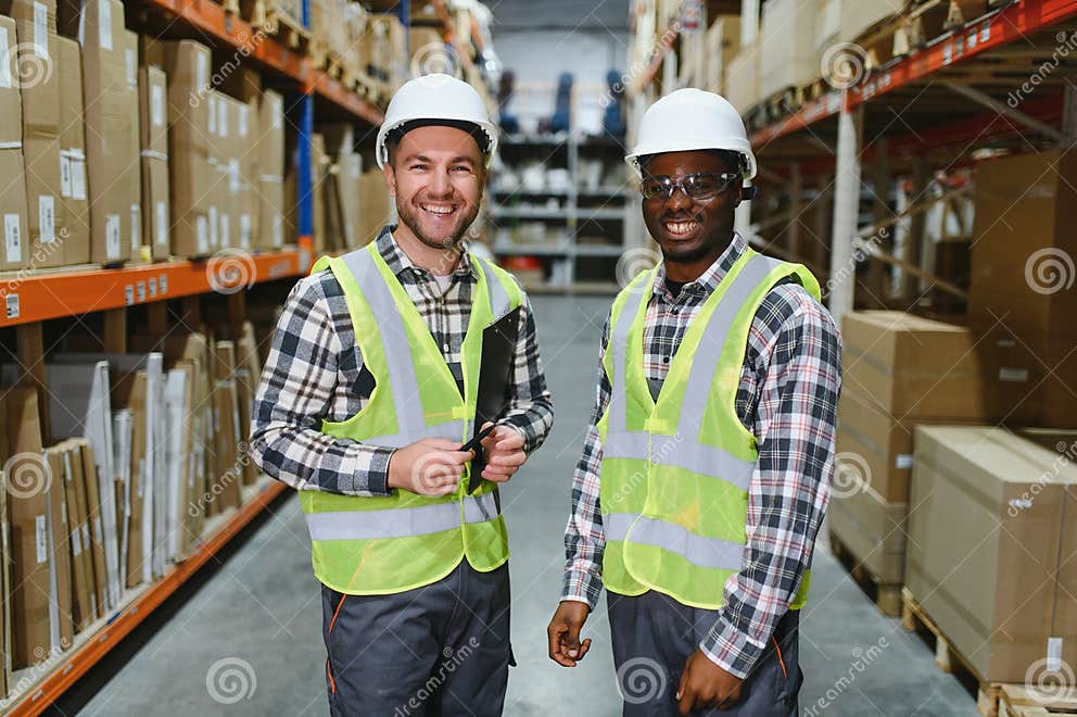 Two Warehouse Workers Checking and Controlling Boxes in Warehouse ...