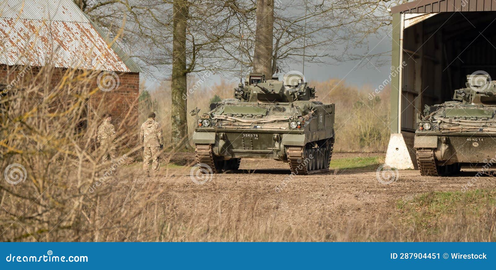 Warrior Tank Parked Side by Side in Front of a Building, Providing a ...