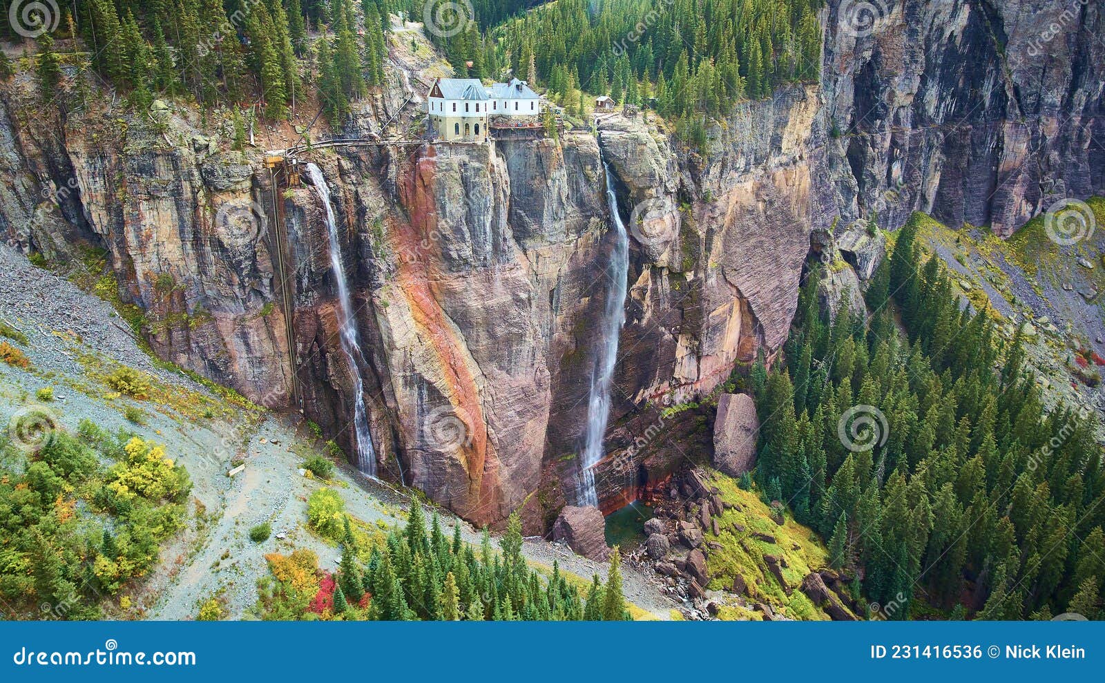 Two Waterfalls Over Giant Cliff Wall with Power Station at Top Stock ...
