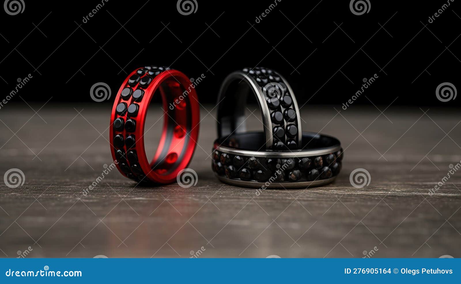 Two Wedding Rings with Black and Red Rings on a Table Stock ...