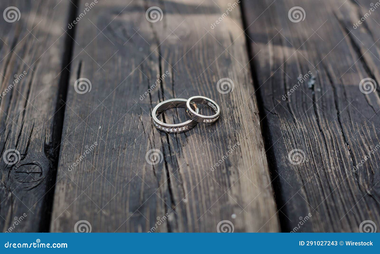 Two Wedding Rings Placed on a Wooden Surface, Illuminated by a Natural ...