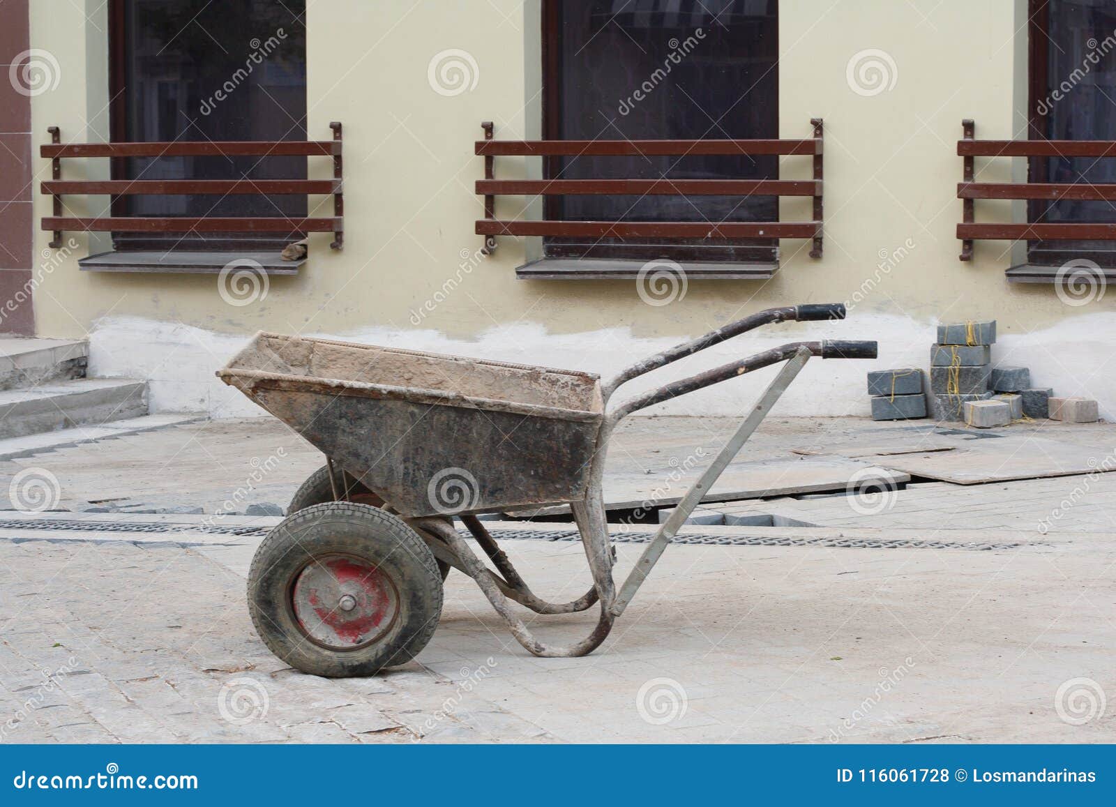 Two-wheeled Wheelbarrow on a Construction Site of a Granite Pavement ...