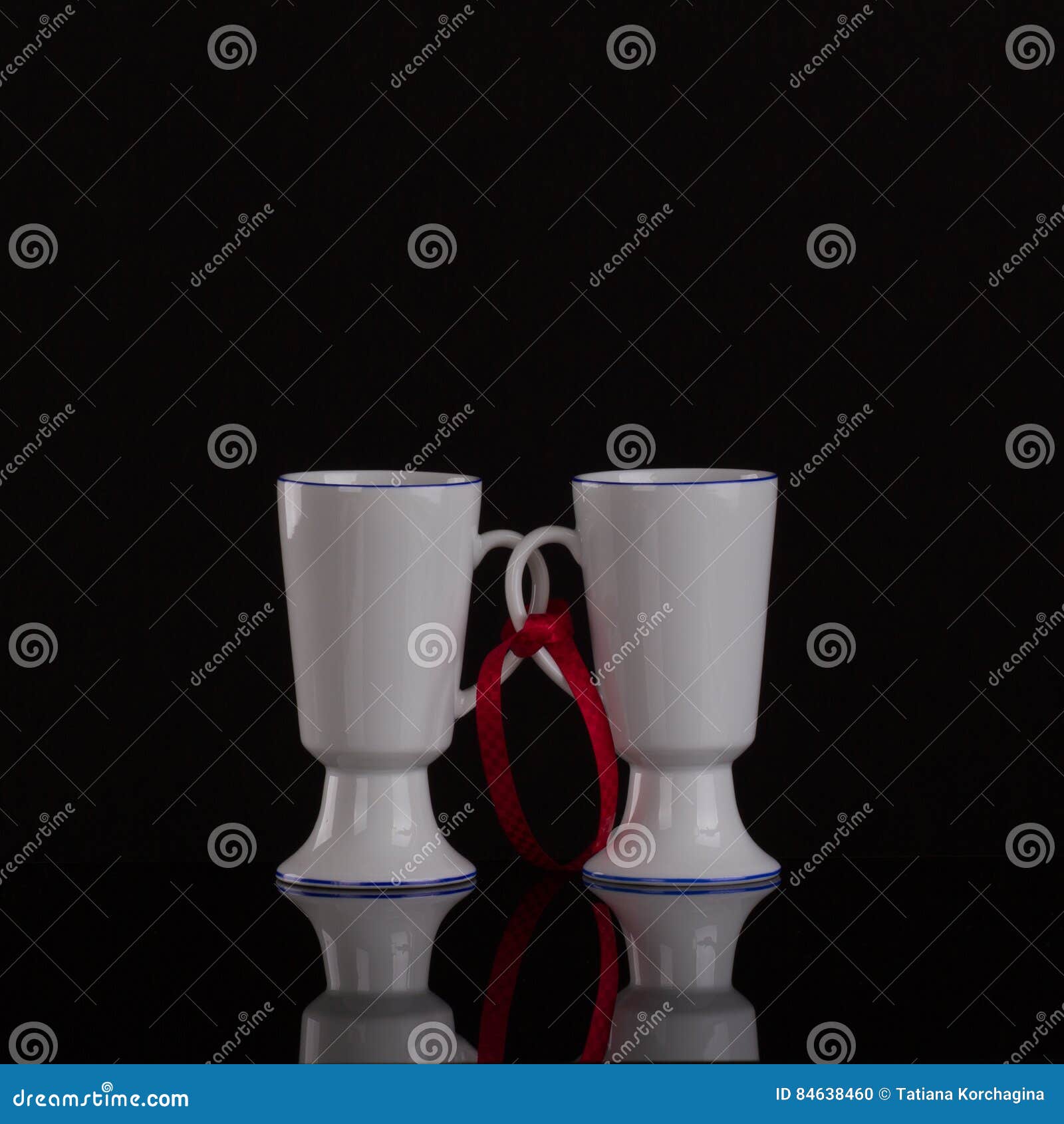 Two White Cups on the Associated with a Red Ribbon. Stock Photo - Image ...
