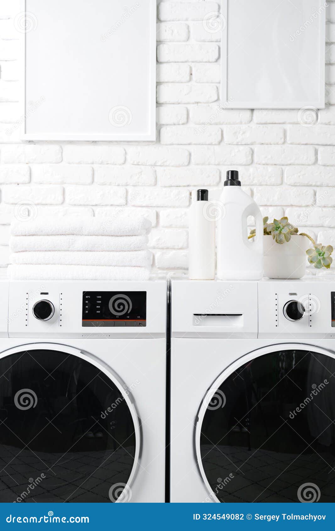 Two White Front Loading Washing Machines in Modern Laundry Room Stock ...