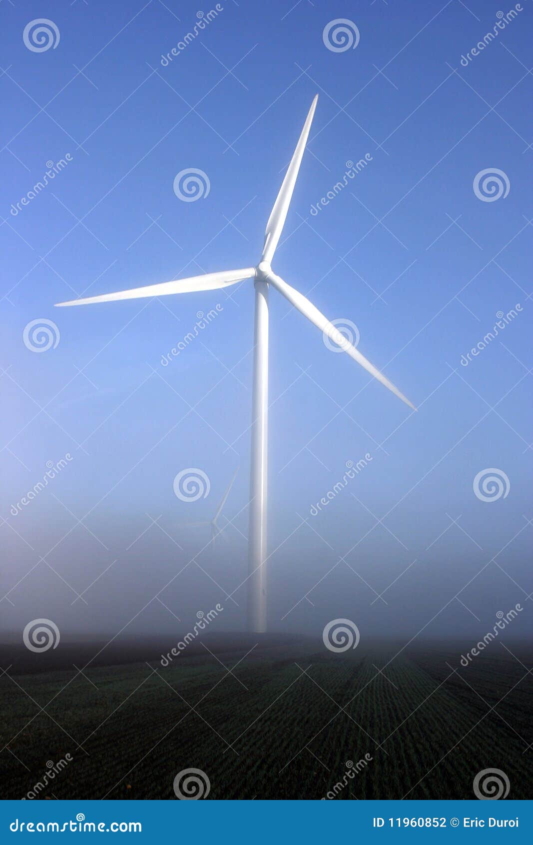 Two Wind Turbines Emerging from Mist Stock Photo - Image of electricity ...