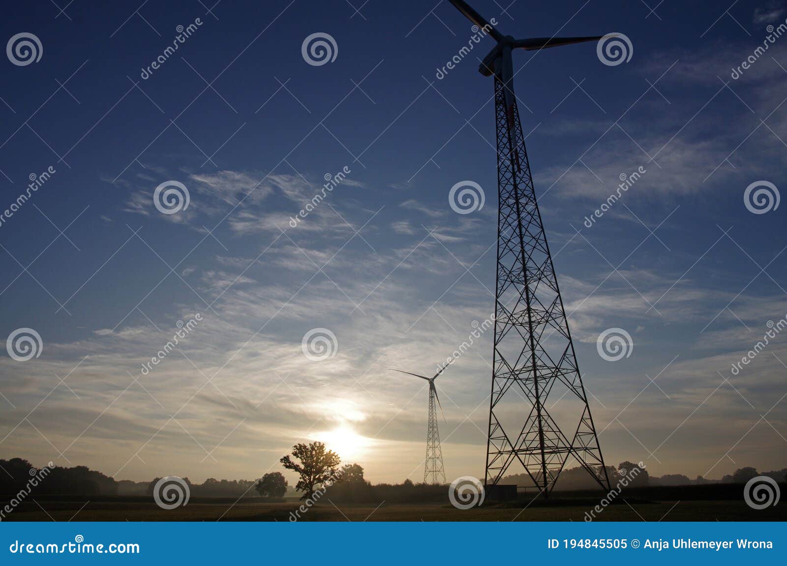 Two windmills at sunrise stock image. Image of industry - 194845505