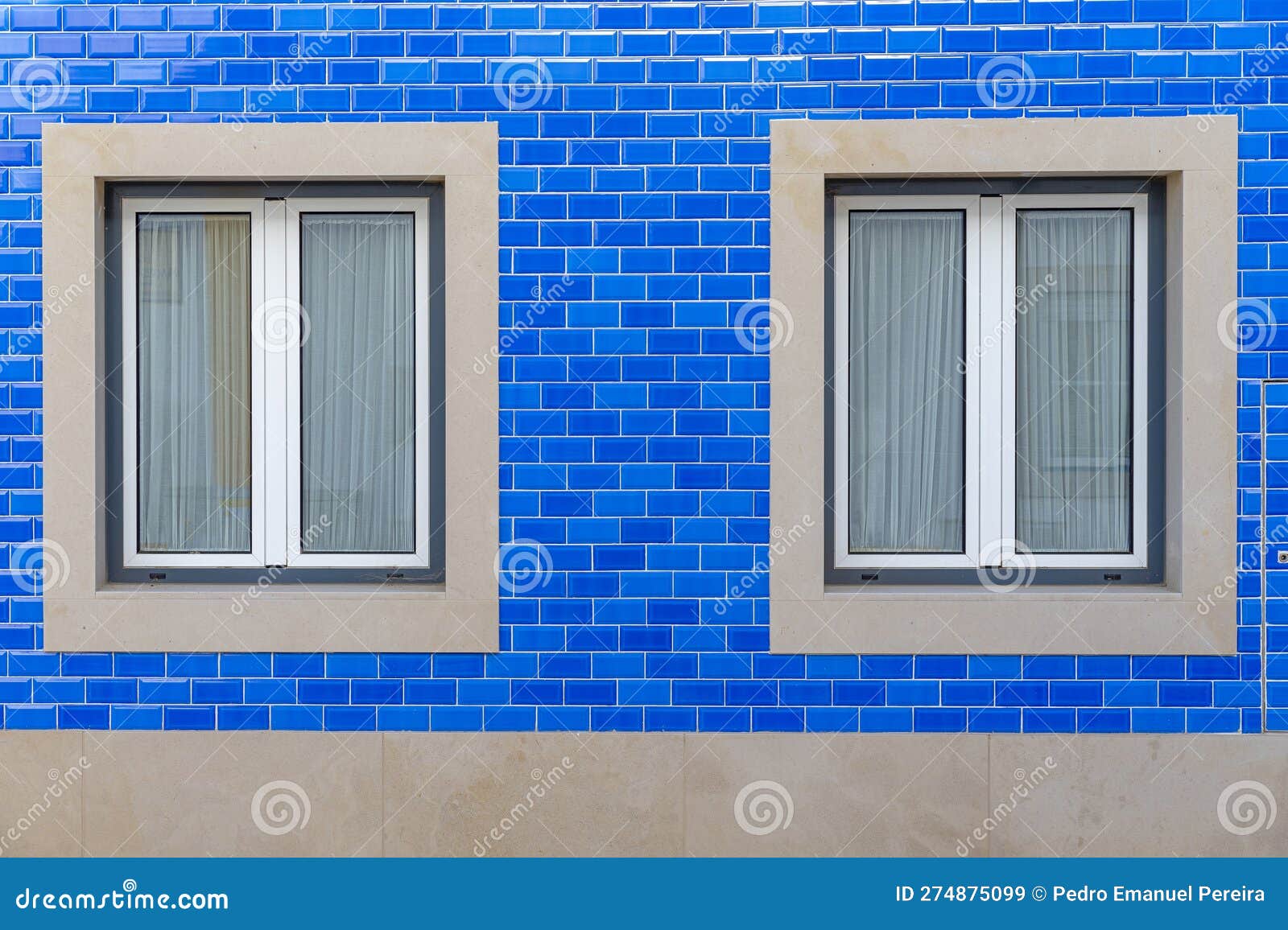 Two Windows on the Facade of a Residence with a Blue Tiled Wall Stock ...