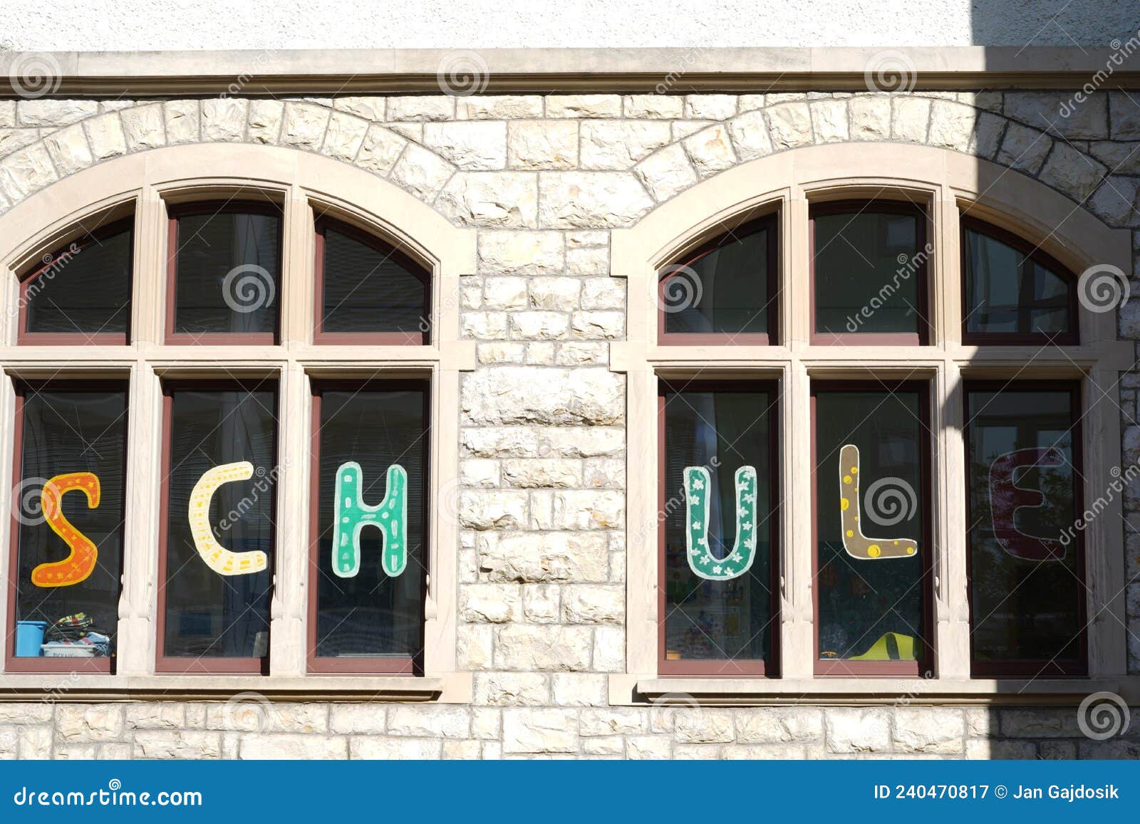 Two Windows with Letters Saying School in German Language Visible from ...