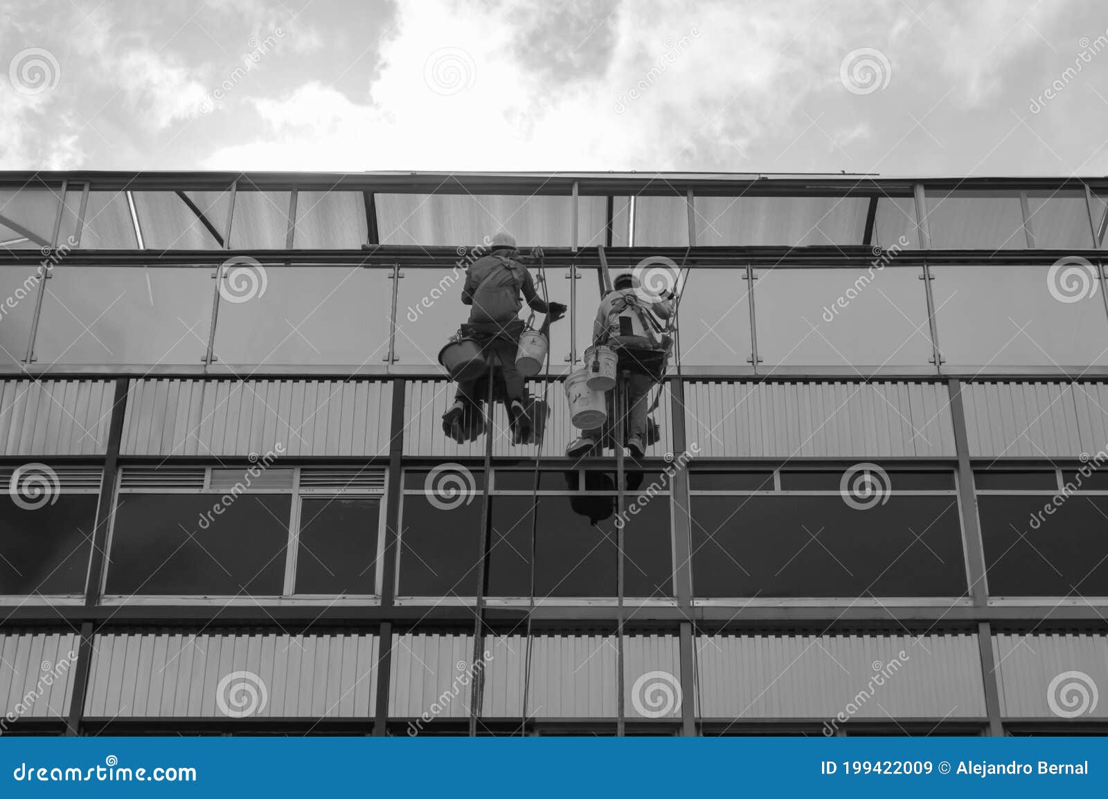 Two Windows Washers Doing His Job at High Modern Skyscraper with Cloudy ...
