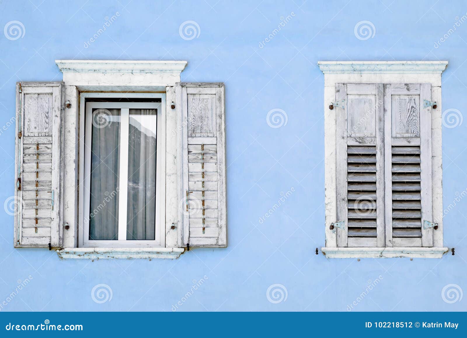 Two Windows with Window Shutters in a Blue House Stock Photo - Image of ...