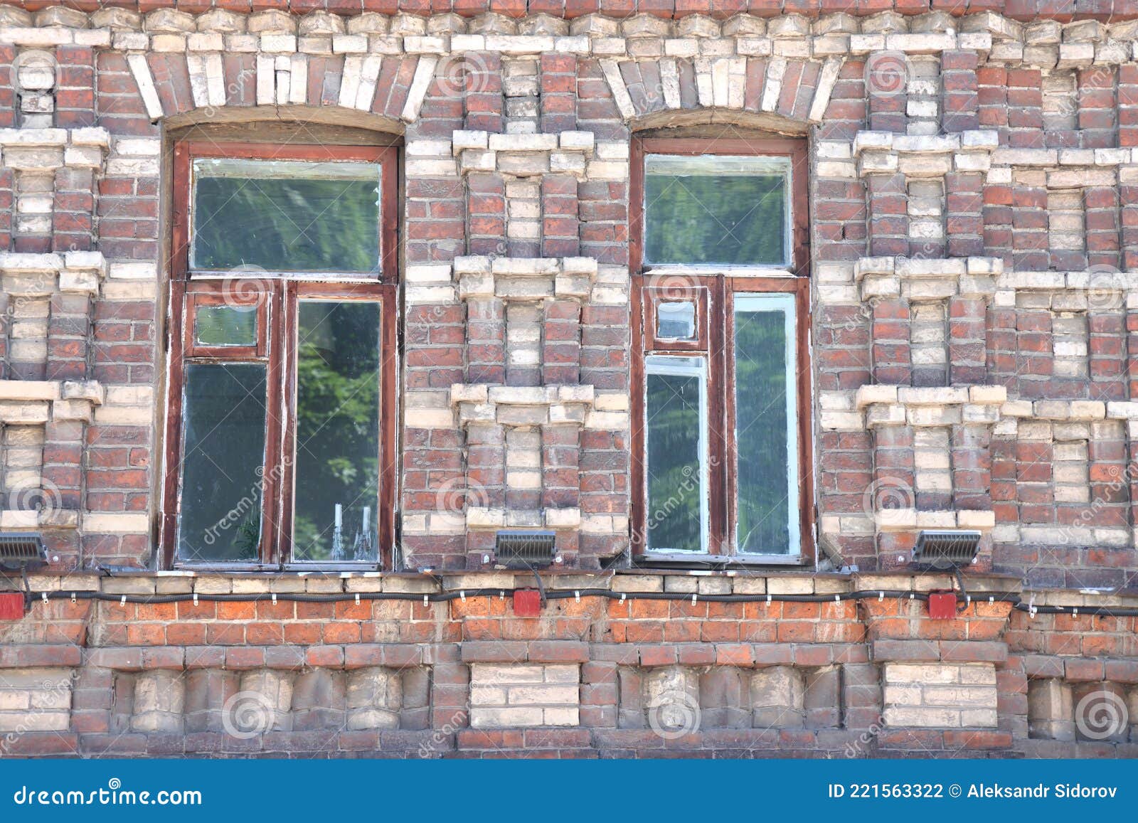 Two Windows with Wooden Frames in a Brick Wall with Embossed Masonry ...