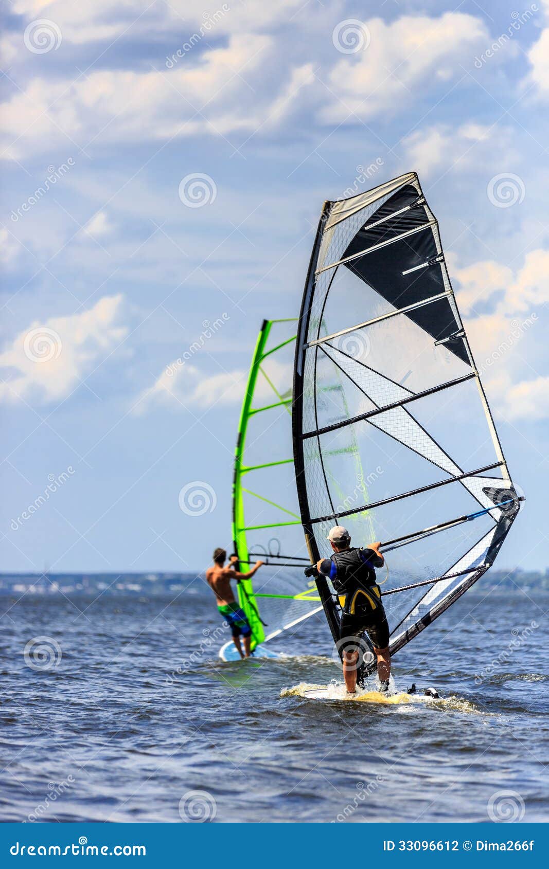 Two windsurfers in action stock photo. Image of sport - 33096612