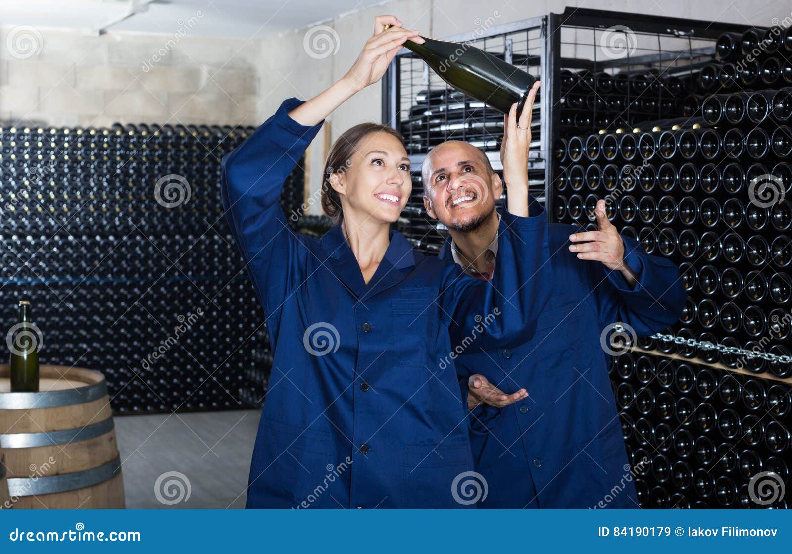 Two Winery Workers Holding Bottle of Wine Stock Image - Image of ...