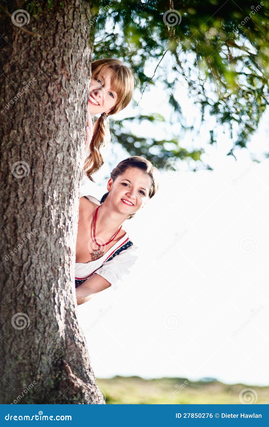 Two Woman behind a Tree stock photo. Image of nature - 27850276