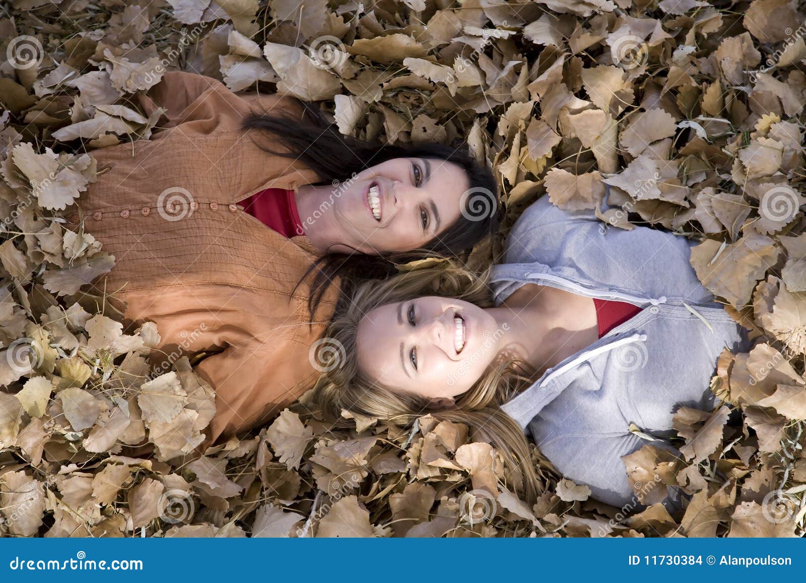 Two Woman in Leaves Eyes Open Stock Photo - Image of laying, fall: 11730384