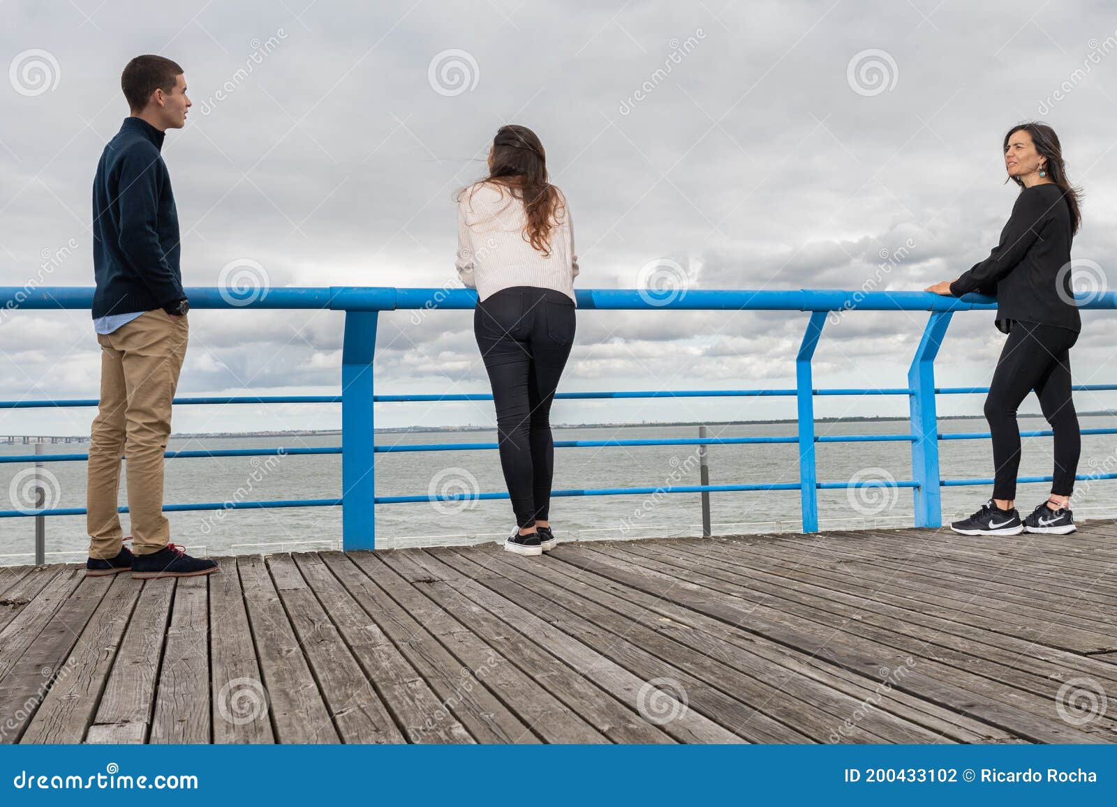 Two woman and one man stock photo. Image of path, building - 200433102