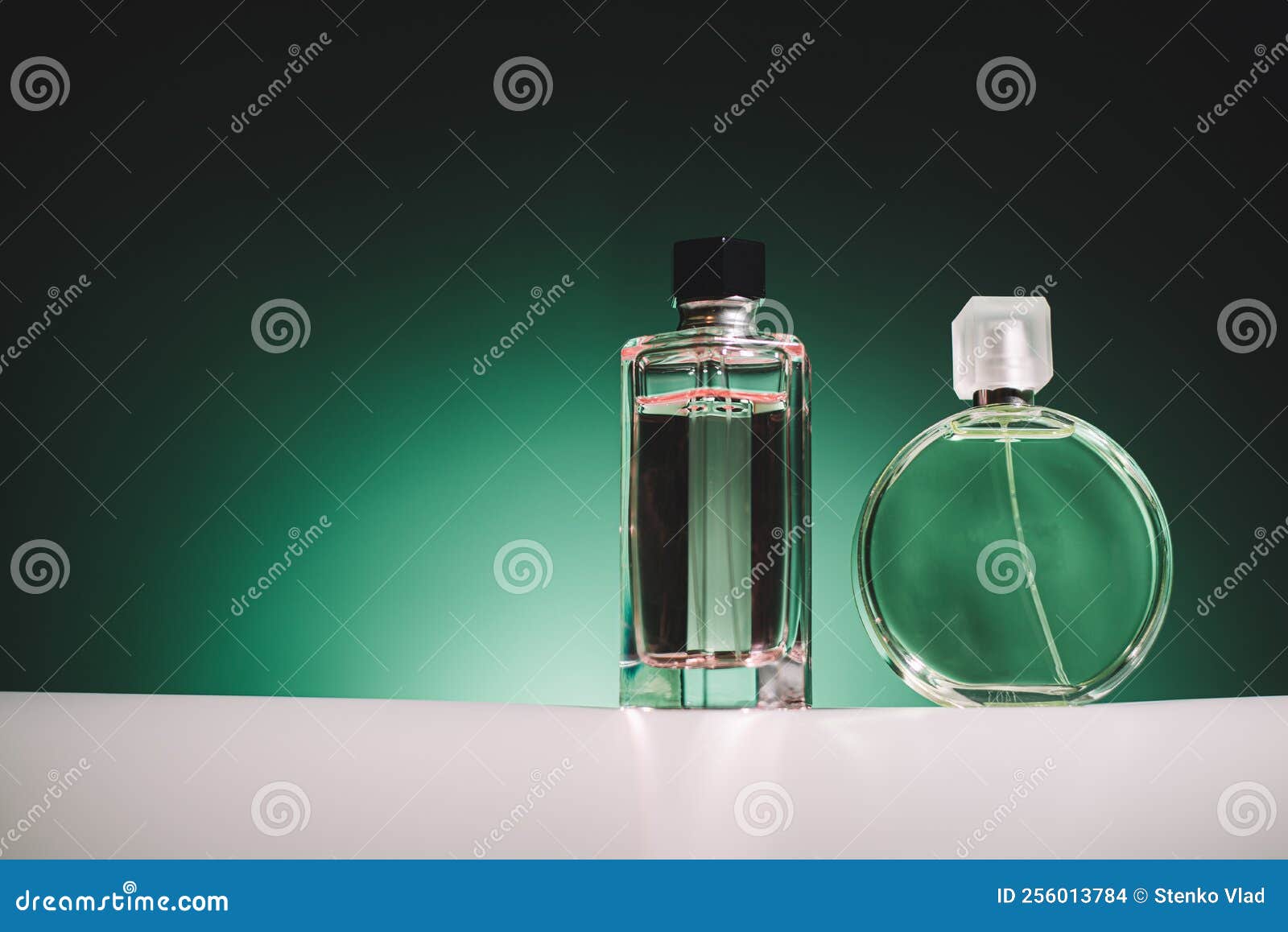 Woman Perfume Bottles on Green Background. Choice Perfume Stock Photo ...
