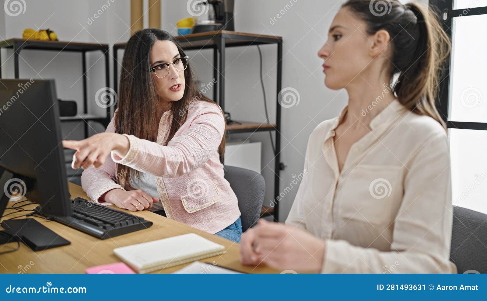 Two Women Business Workers Using Computer Speaking at Office Stock ...