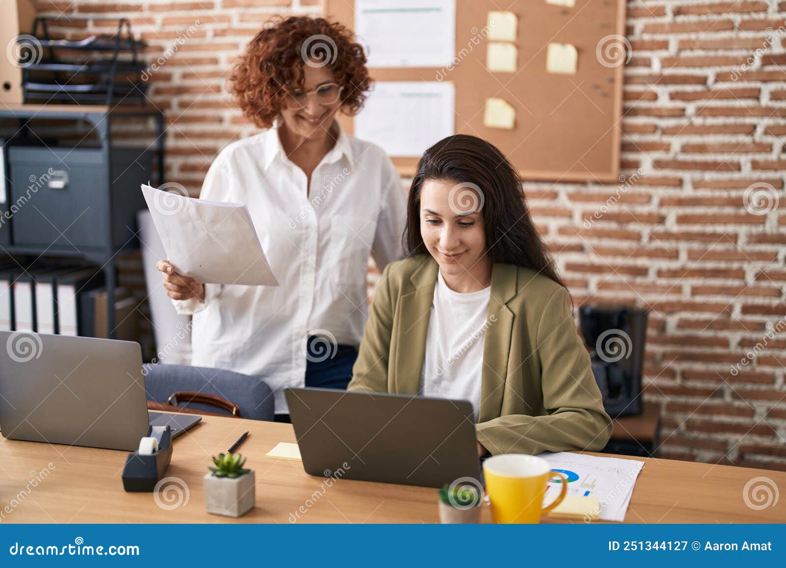 Two Women Business Workers Using Laptop Reading Document at Office ...