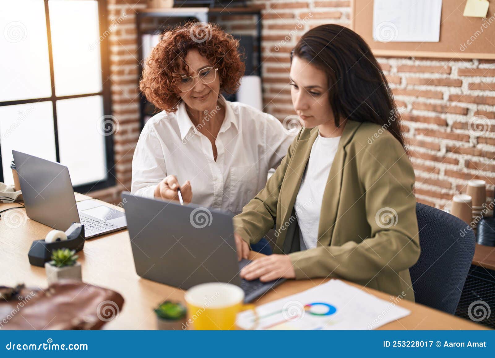 Two Women Business Workers Using Laptop Speaking at Office Stock Image ...