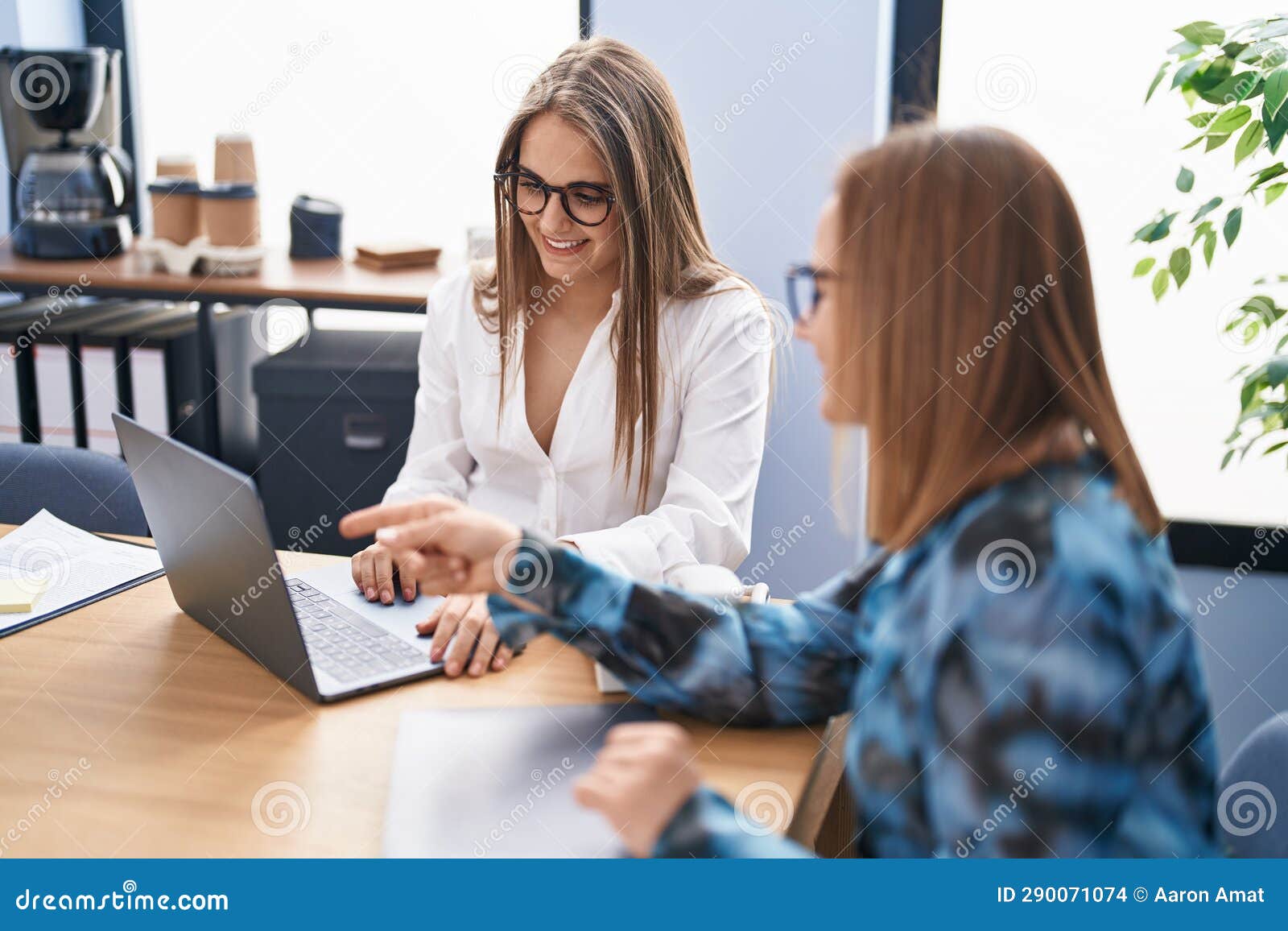 Two Women Business Workers Using Laptop Speaking at Office Stock Photo ...