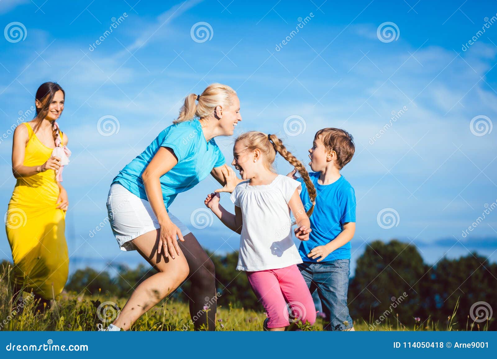 Two Women with Children Playing Tag Stock Photo - Image of playing ...