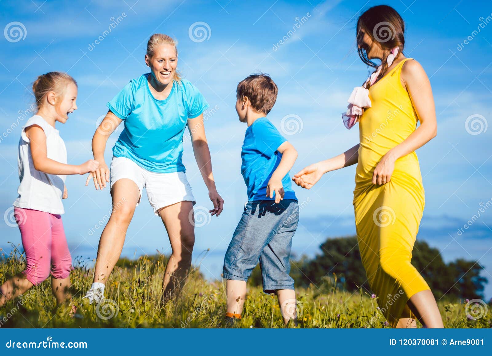 Two Women with Children Playing Tag Stock Image - Image of people ...