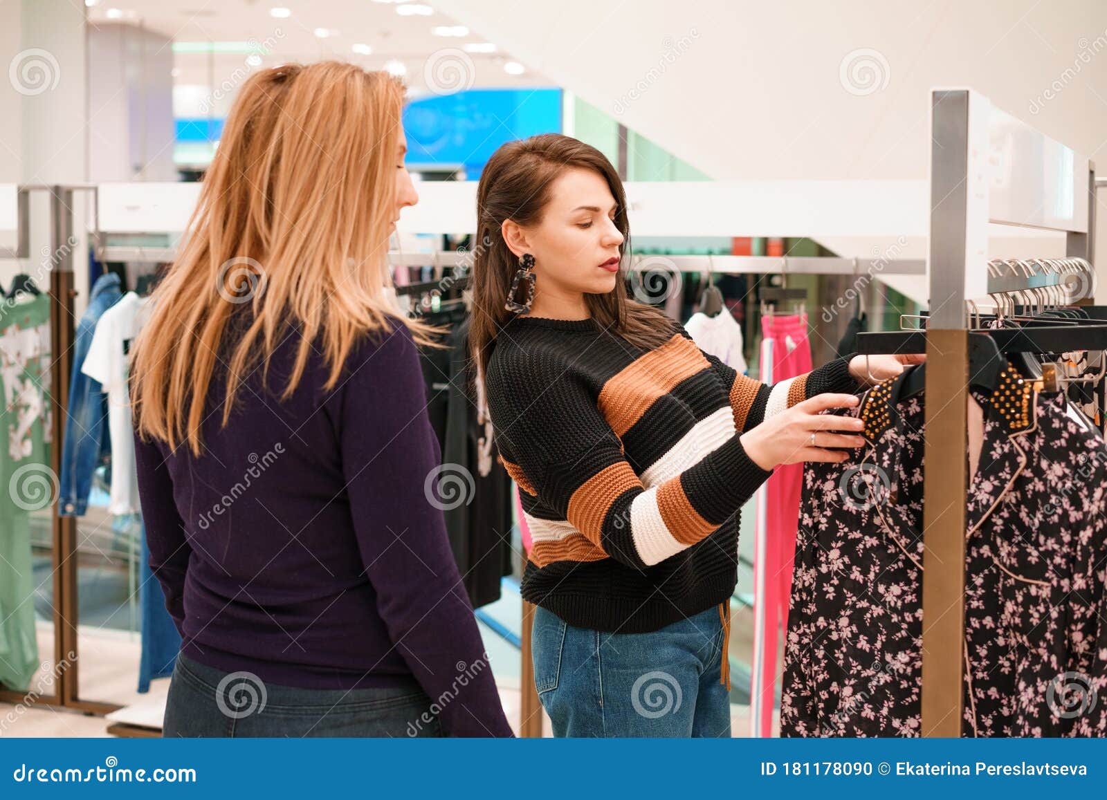 Two Women Choose Clothes in a Store Stock Photo - Image of people ...