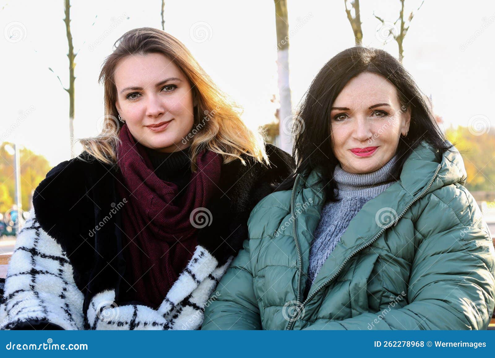 Two Women in Coats Sitting Outside on a Bench Stock Photo - Image of ... Two Women in Coats Sitting Outside on a Bench Stock Photo - Image of ...