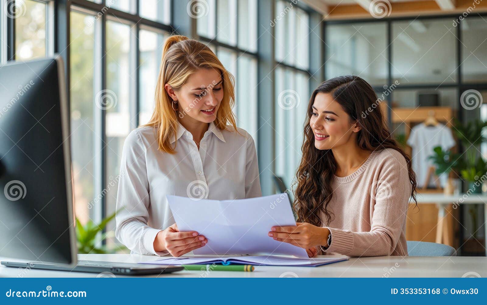 Two Women Collaborating on a Project in a Modern Office Stock Photo ...