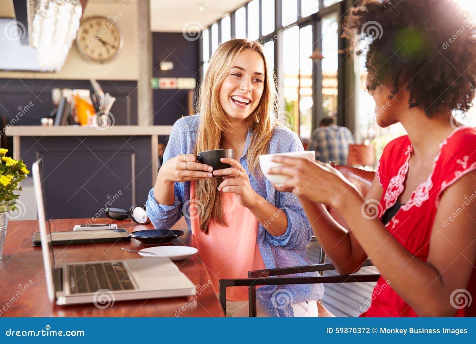 Two Women with Computer Laughing in a Coffee Shop Stock Photo - Image ...