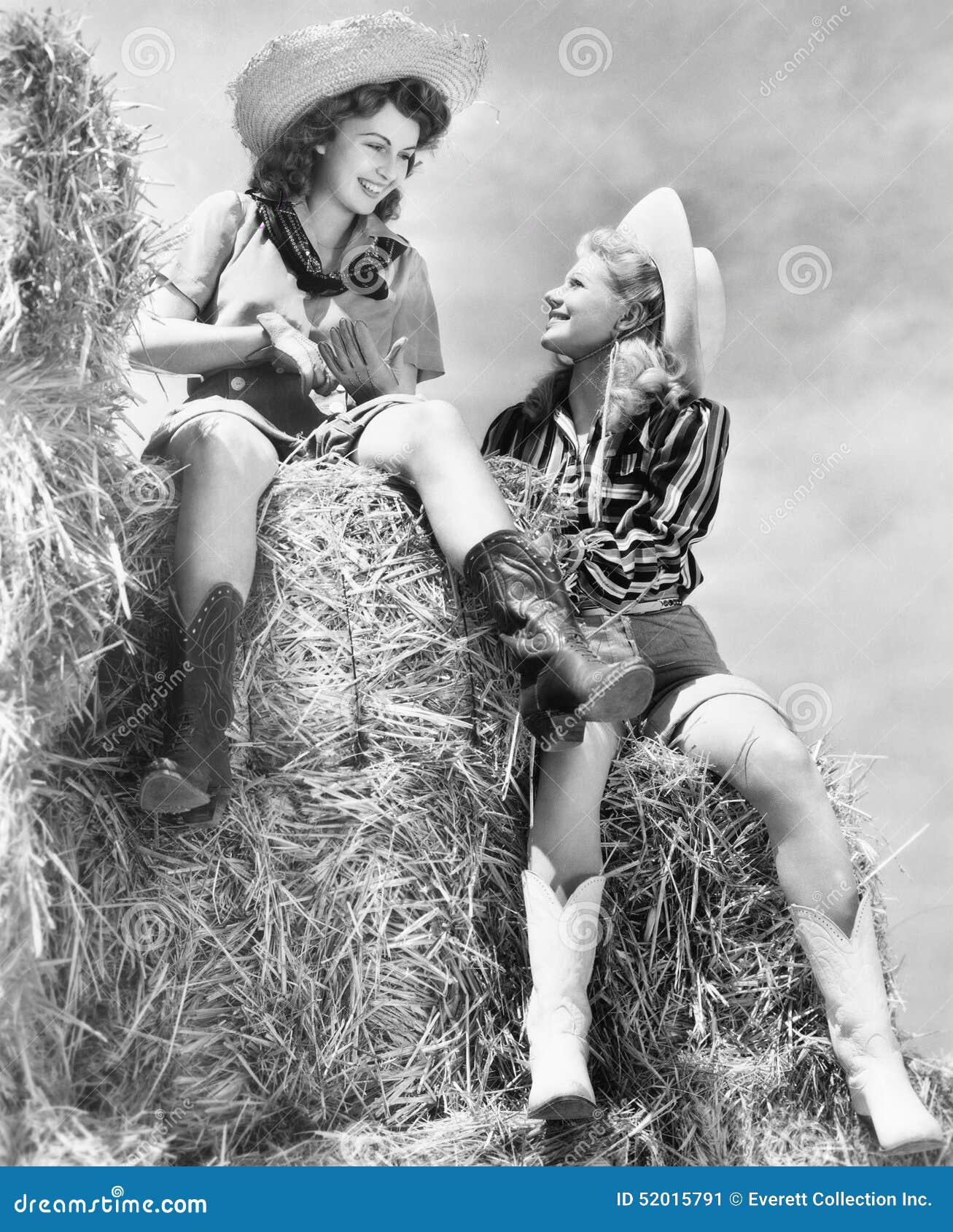 Two Women in Cowboy Hats Sitting on a Haystack Stock Image - Image of ...