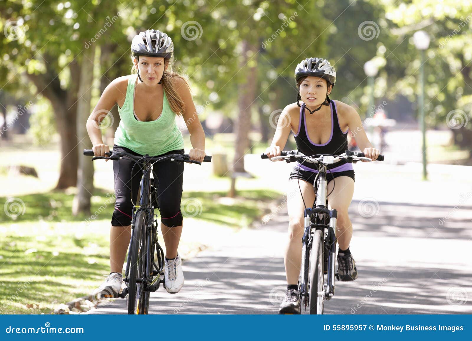 Two Women Cycling through Park Stock Image - Image of cycling, bike ...