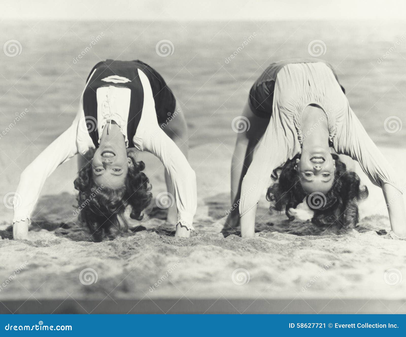 Two Women Doing Backbends on the Beach Stock Image - Image of ...