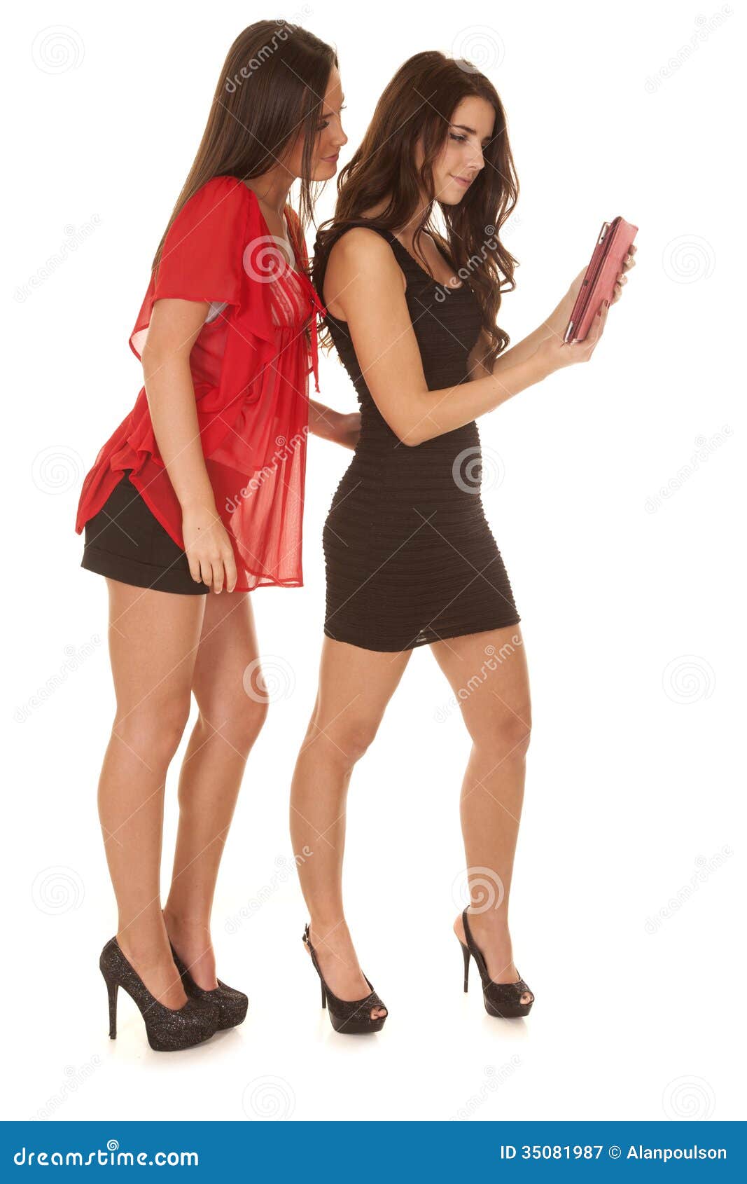 Two Women Dressed Up Look at Tablet Stock Image - Image of cute ...
