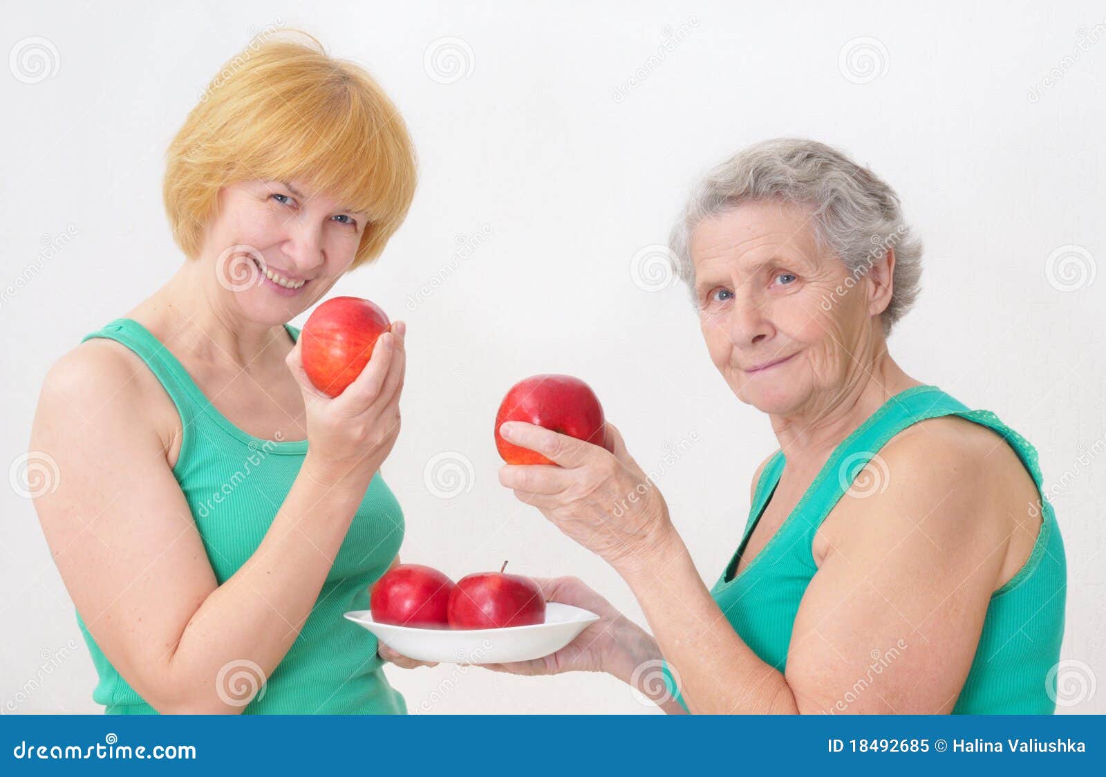 Two women eating an apples stock image. Image of care - 18492685