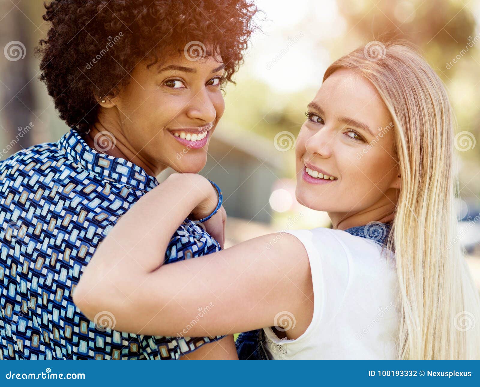 Two women friends in park stock photo. Image of finger - 100193332